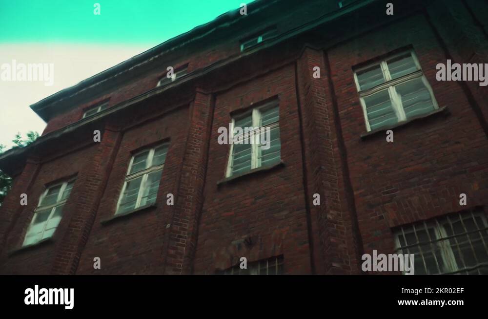 Retro red brick house through windshield of car with drops in cloudy ...