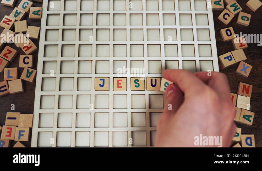 Jesus Christ. Colourful wooden square letters creating the name of ...