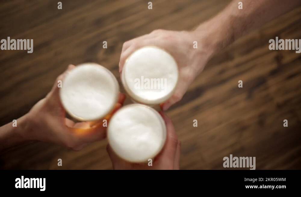 3 Men Hands Toasting With Full Beer Pint Glasses, Top Down Close Up ...