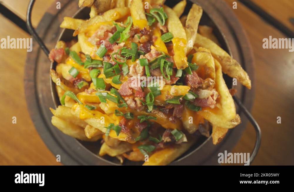 Top down shot of rotating Potato Chips - French fries with cheddar ...