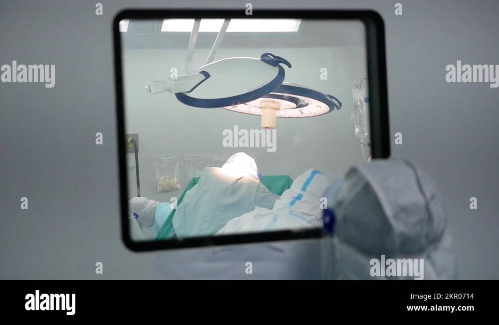 Asian Woman Wear PPE Look Inside Operating Room Window, Close Up Stock ...
