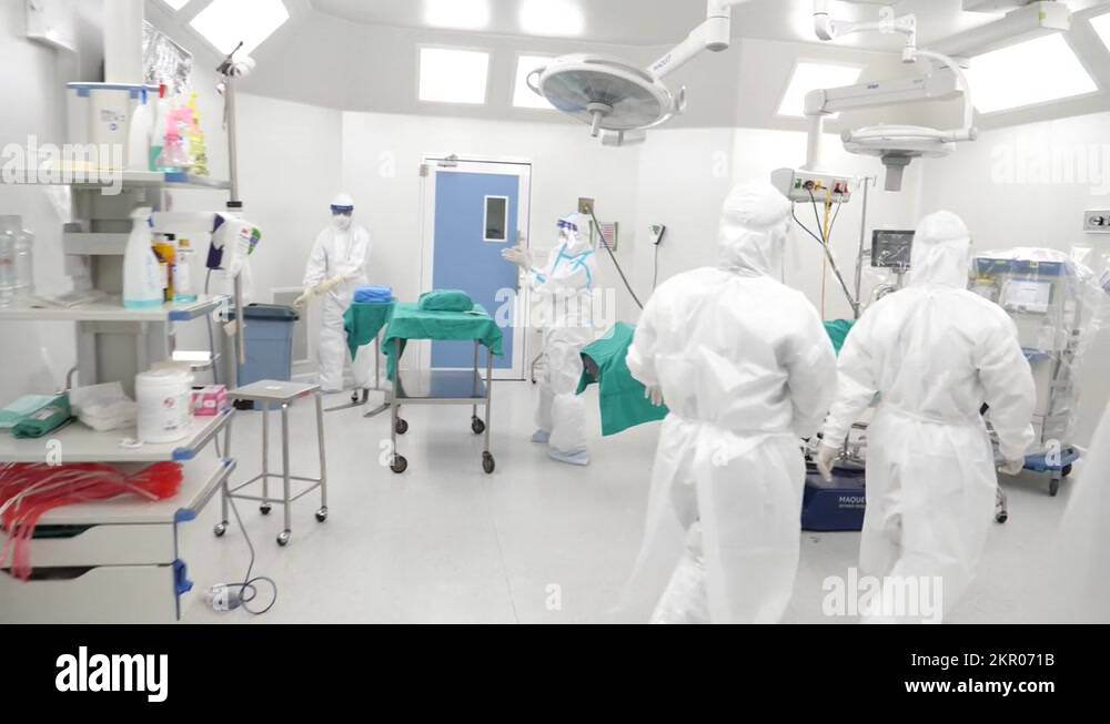 Asian Medical Staff Wear PPE Walk Into Operating Room With Patient On ...