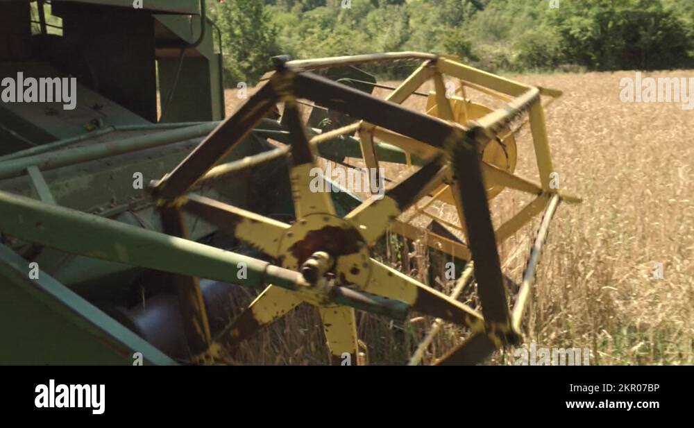 Rotating blades of the combine harvester. Close-up. Moving from left to ...