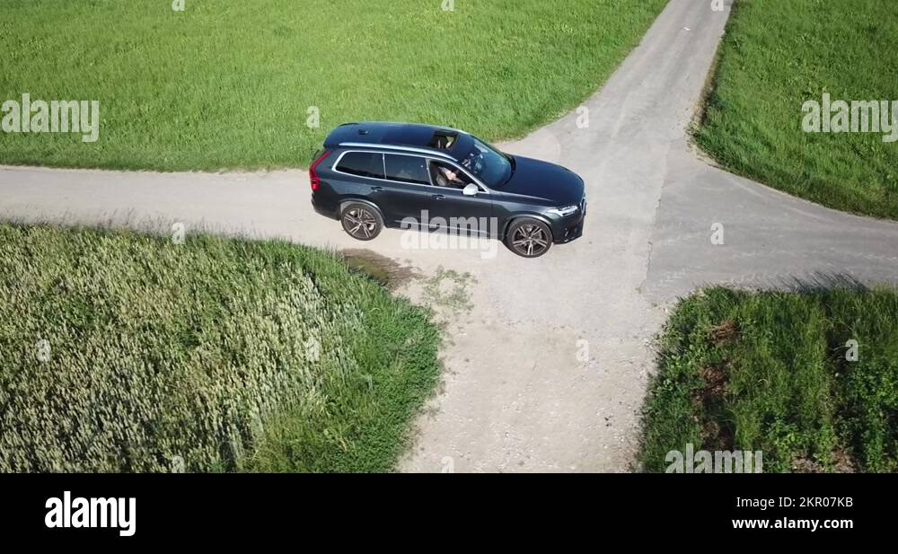 a volvo is stopped at an intersection between two roads in the Stock ...