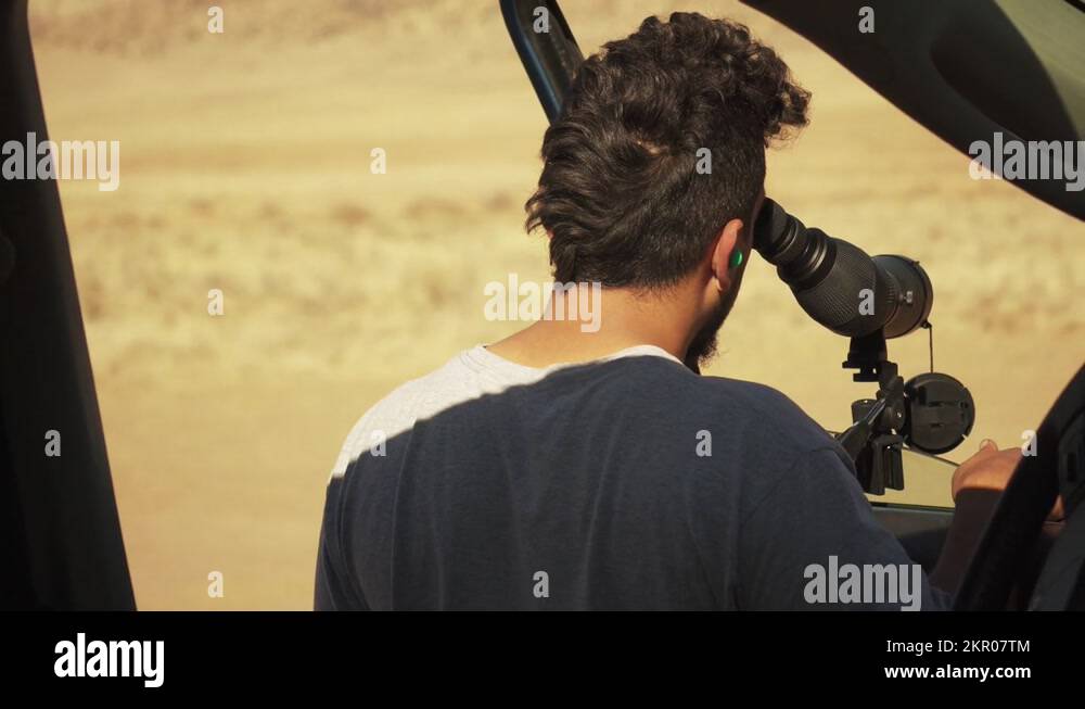 Deerstalker Scout on hunt, looking through spotter scope for deer in ...