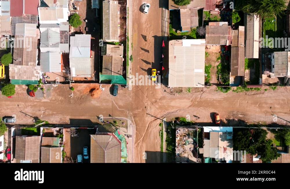 Aerial birds eye view of dirt streets during daytime of the beach town ...