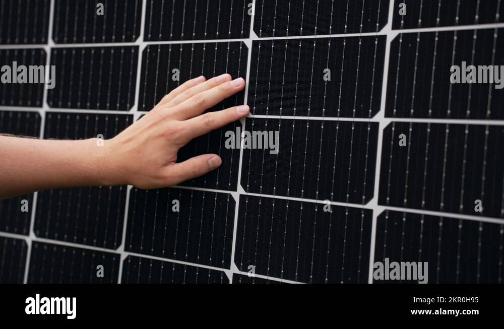 Hand inspecting efficient solar panel, touching cells, closeup, static ...