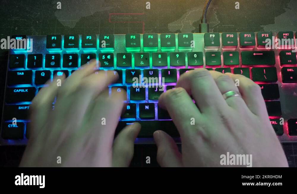 Man typing on a pc keyboard with RGB lights during the night Stock ...