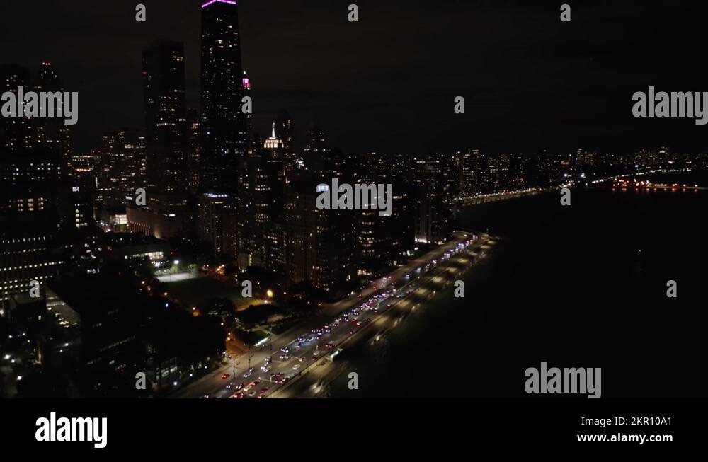 Pan Up Reveals Lake Shore Drive and Hancock Building at Nighttime in ...