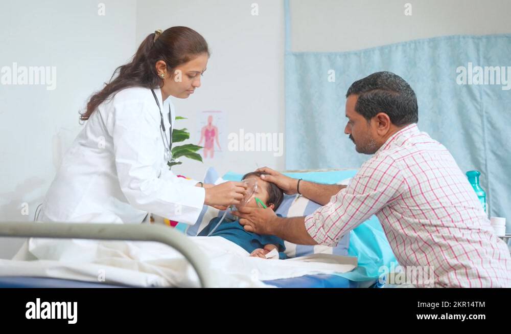 Doctor wearing oxygen mask to sick child at hospital ward - concept of ...