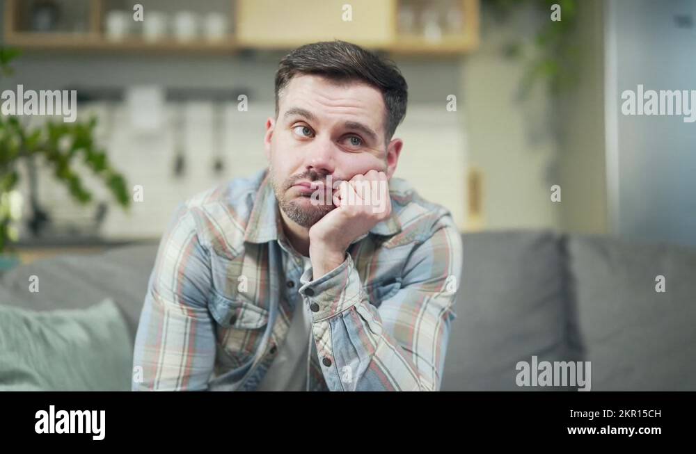 Portrait Bored exhausted sad young man bearded handsome man sitting ...