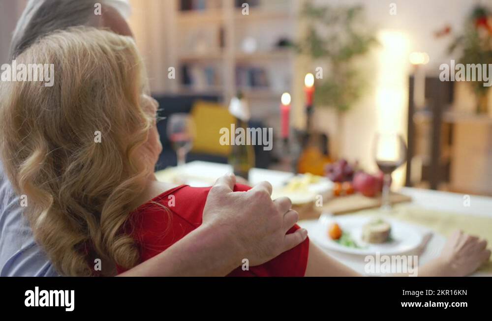 Back view of couple hugging, romantic mood, candle light dinner ...