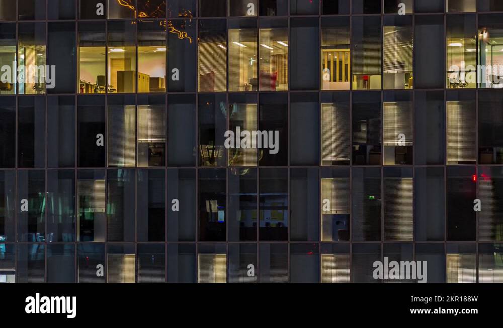 Night aerial view of office building glass window facade with ...