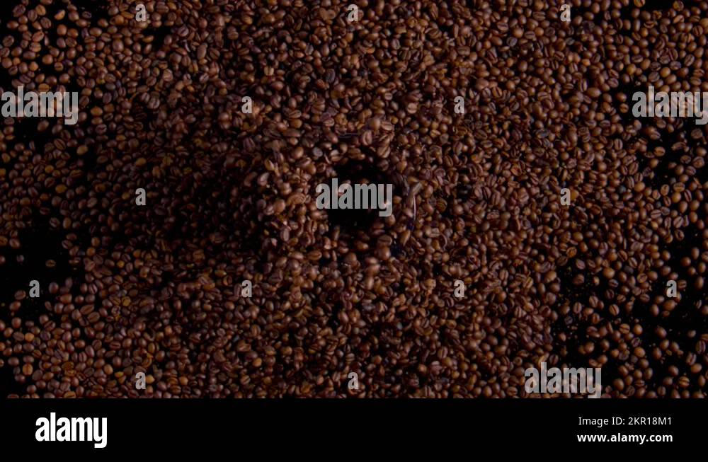 Roasted coffee beans milling in electric grinder with open cover close ...