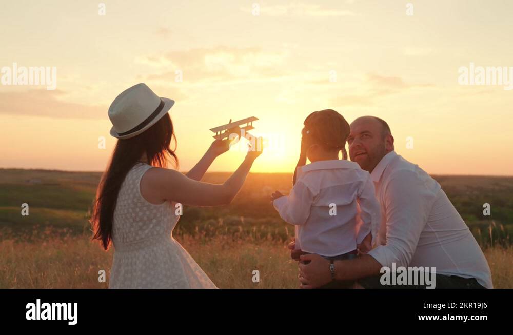 Kid plays in pilots helmet in his hand plane, Active family, dad, mom ...