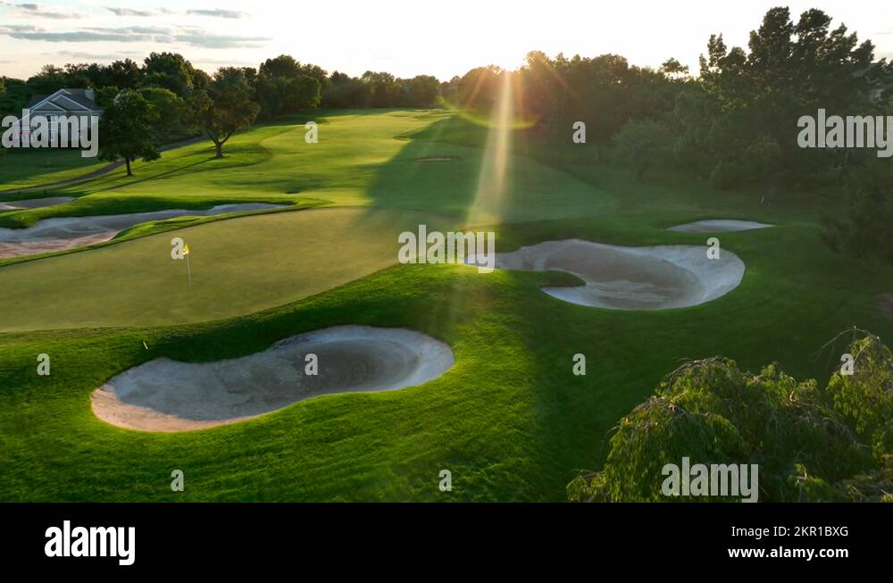 Golf course sand bunker and putting green. Aerial at sunset in summer ...