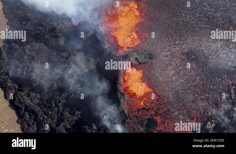 Magma spewing from fissure volcano eruption in Iceland, sunny day ...