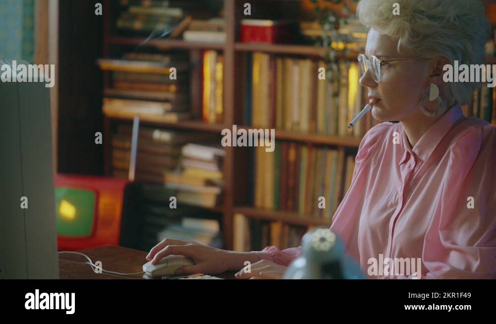 Workaholic woman smoking cigarette working on computer in office ...