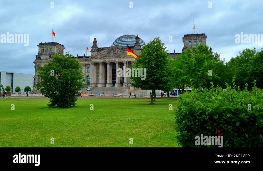 Side view of the Reichstag Building in Berlin, Germany with massive flags Stock Video Footage ...