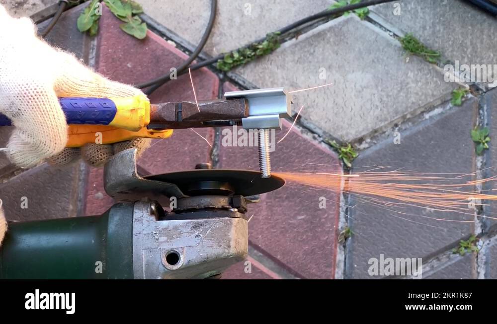 Cutting bolt with angle grinder with sparks flying Stock Video Footage ...
