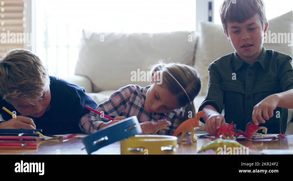 Siblings bonding by drawing pictures in together as a family. Young ...