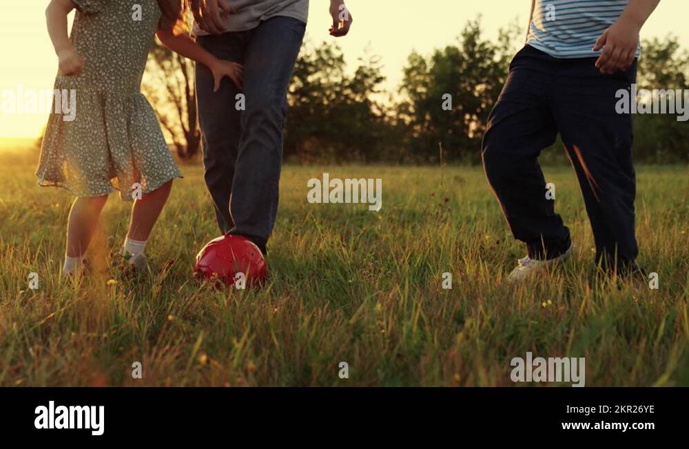 Children son daughter play football with father on lawn. Active happy ...