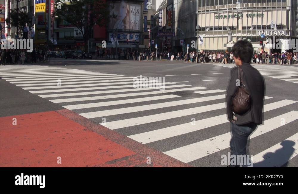Pedestrians cross the Shibuya intersection in Tokyo, Japan Stock Video ...