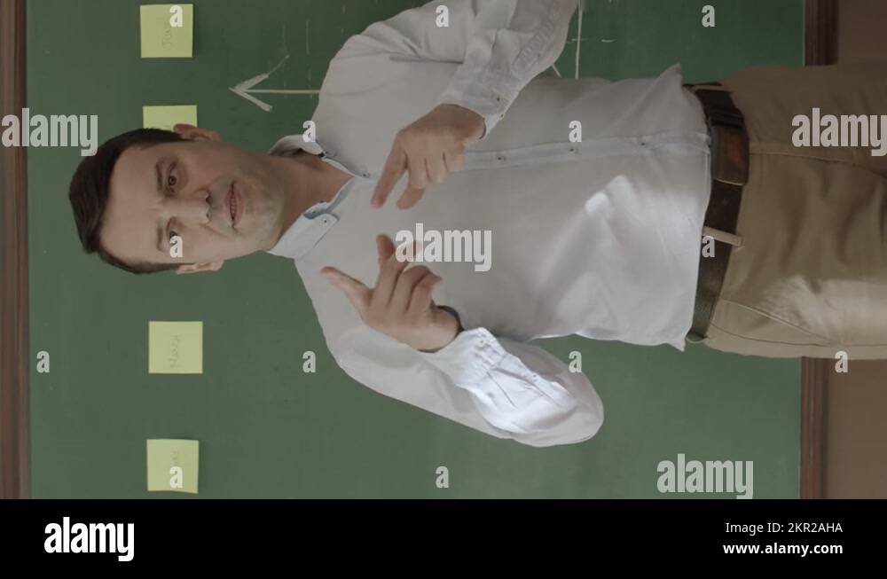 A businessman explains to employees how sales should be with graphs ...