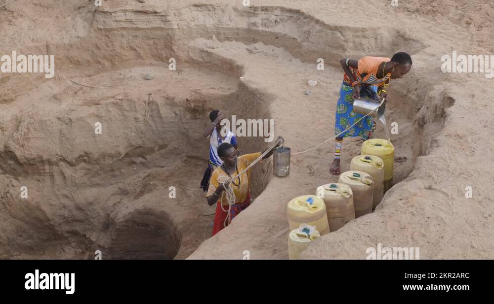 Climate change.drought.Close-up.African woman collecting water from ...