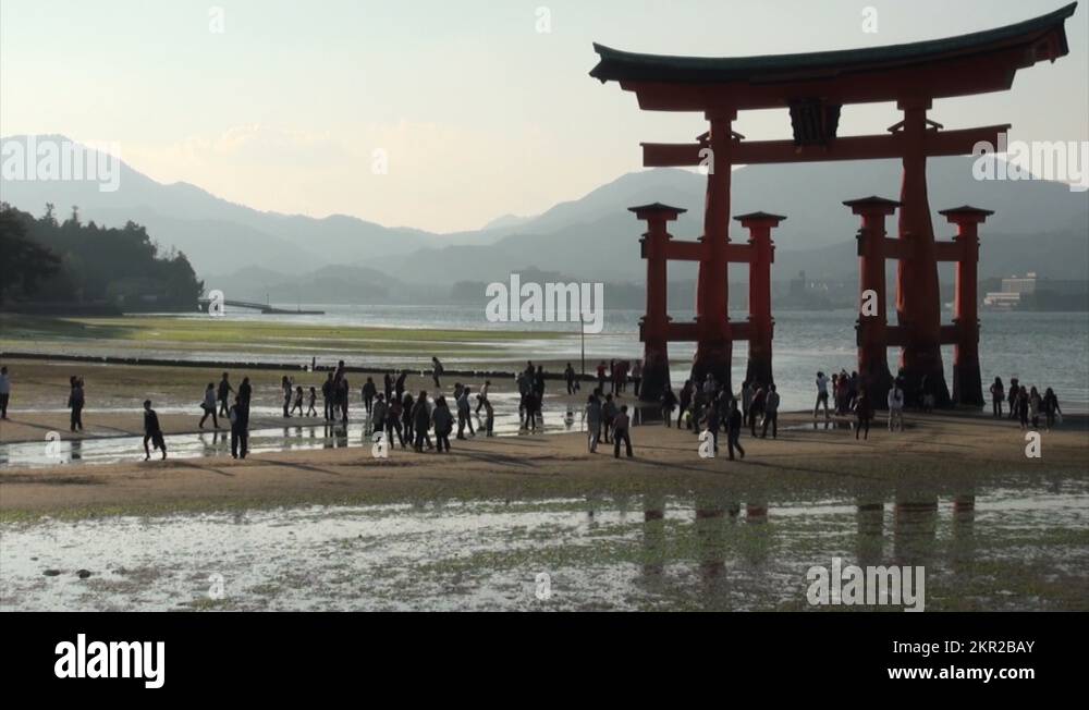 People visit the floating torii gate at Miyajima island in Japan Stock ...