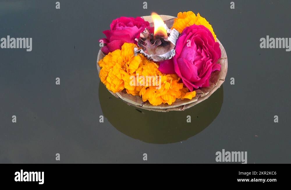 hinduism religious ceremony puja flowers and candle on Ganges water ...