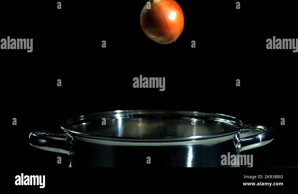 Onion falling in pot Stock Video Footage - Alamy