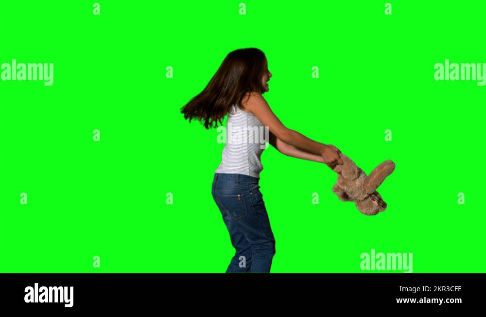Little girl throwing and catching teddy on green screen Stock Video ...