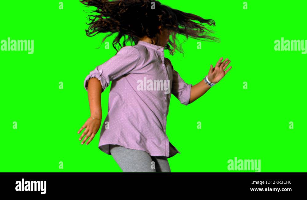 Girl jumping and spinning on green screen Stock Video Footage - Alamy