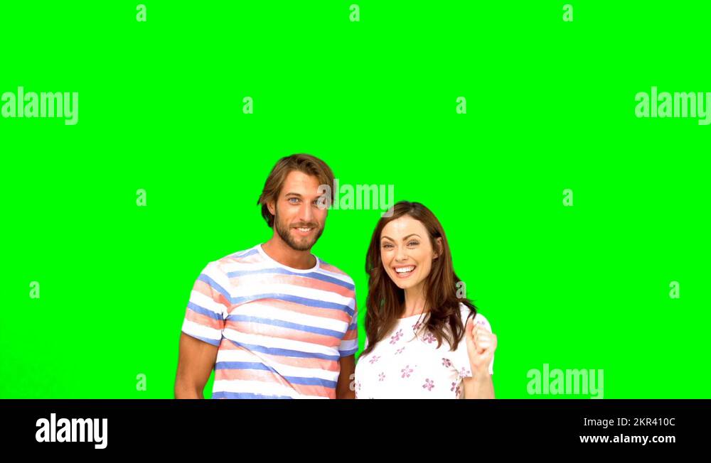 Two friends raising their arms on a green screen Stock Video Footage ...