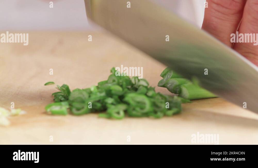 Chopping spring onion leaves into rings Stock Video Footage - Alamy