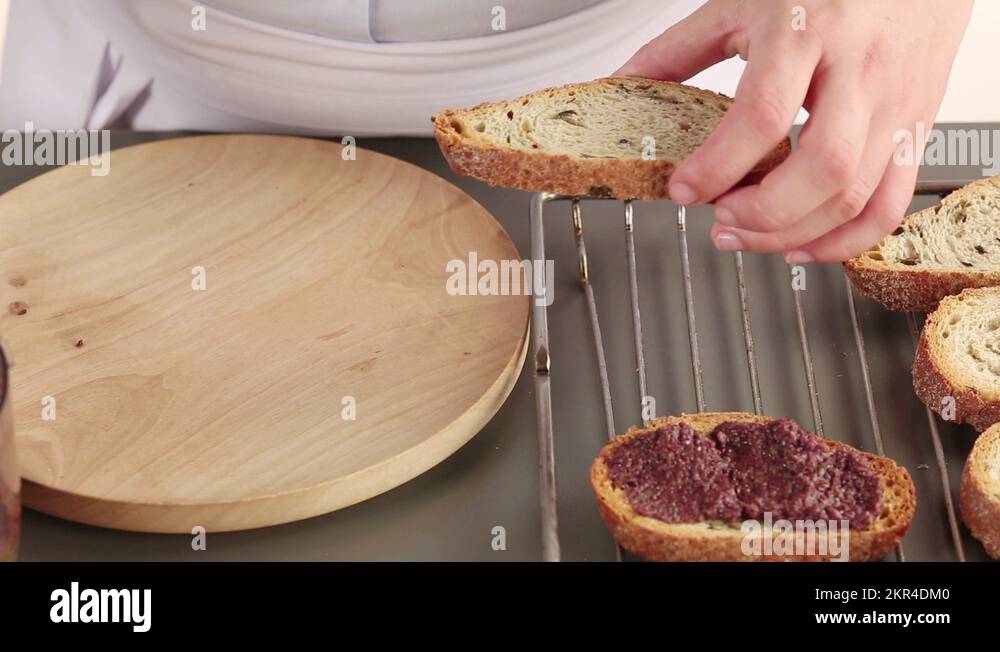 Toasted bread being spread with olive paste Stock Video Footage - Alamy