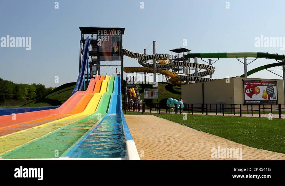 aqua park happy relaxing on water rainbow slide Stock Video Footage - Alamy