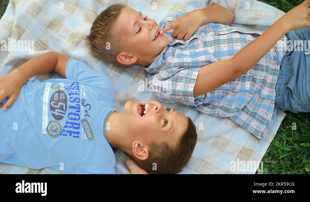 two boys aged 5-7 years lie on your back and look at the sky Stock ...