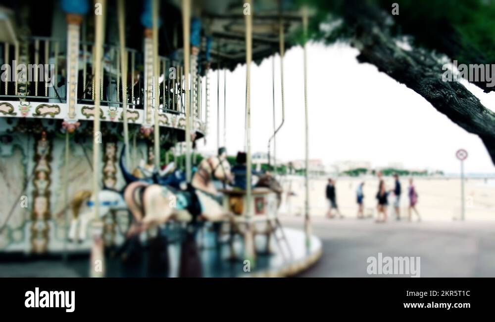 French Carousel On A Beach With Crowd Passing By Stock Video Footage ...