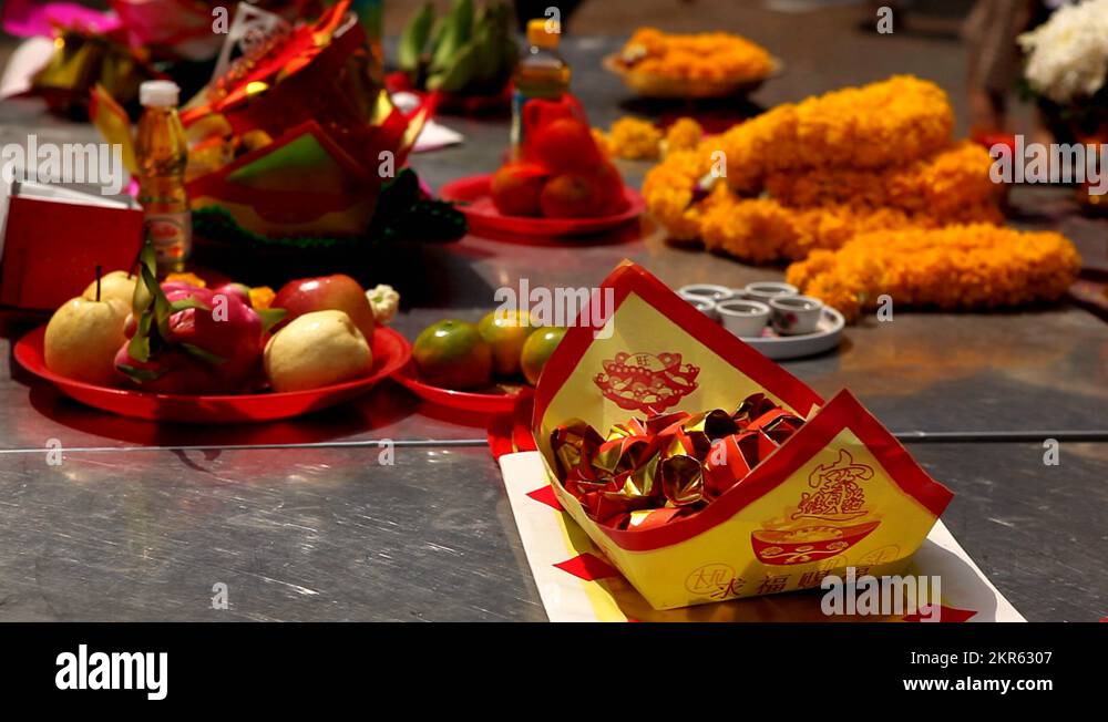 Offerings of fruits, candy are placed on the altar for the various gods ...