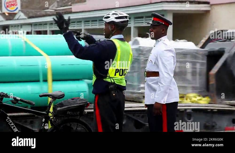 Traffic officer manages rush hour congestion on busy intersection in ...