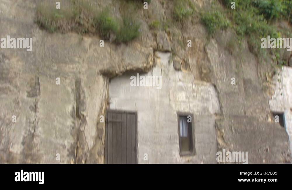 Cave dwelling tilt up/down overgrown limestone blocks facade Stock ...