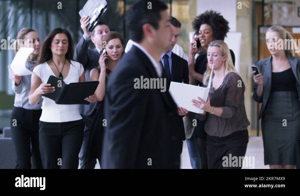 Successful Businessman with his entourage of staff vying for his ...