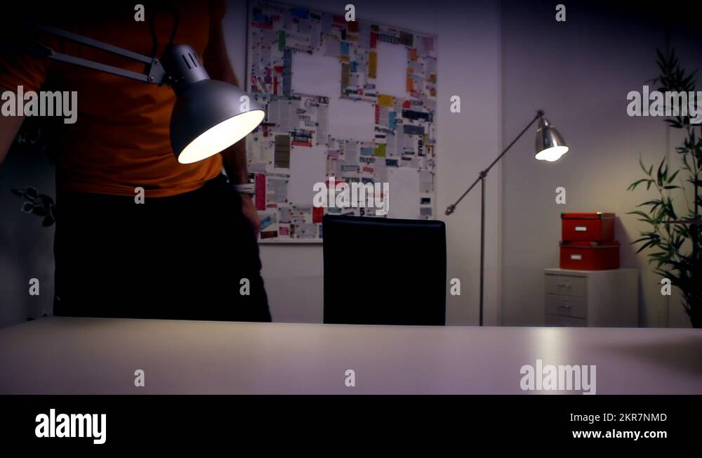 Person at working late under desk lamp with gigantic feet. High quality ...