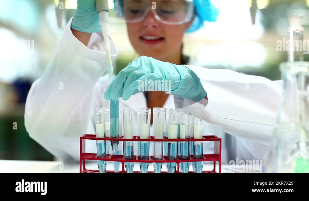 Pretty science student using pipette to fill test tubes Stock Video ...
