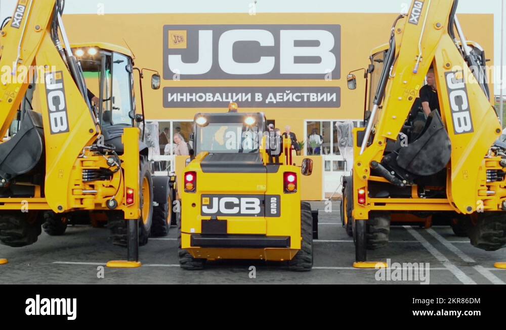 Two JCB excavators lift themselves and loader rides Stock Video Footage ...