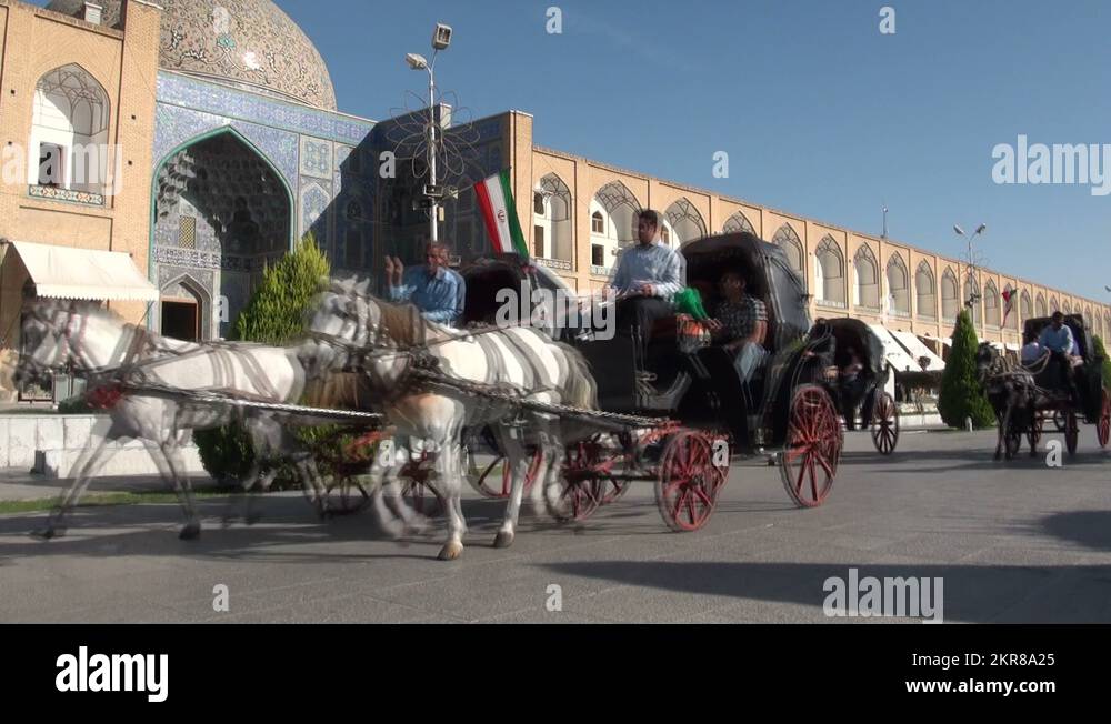 Tourists on horse carts at Imam Square and beautiful mosque, Isfahan ...