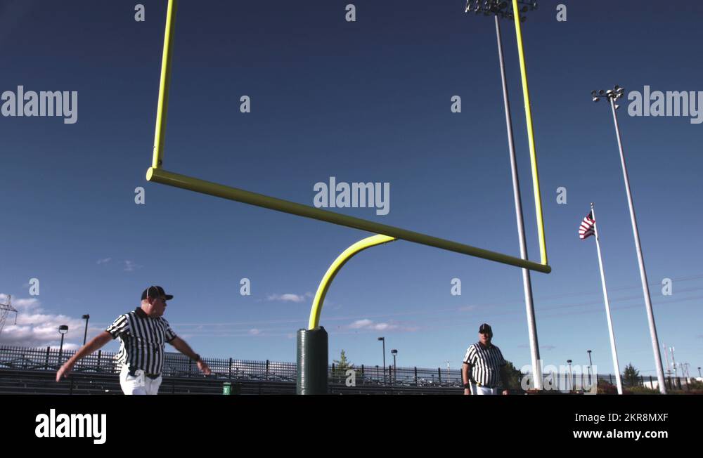Two referees wave their arms back and forth after a missed field goal ...