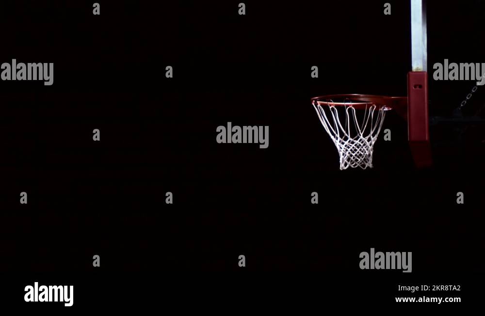 A basketball floats through the air and hits the rim and bounces away ...